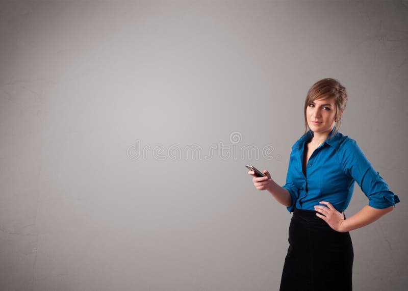 Young Lady Standing and Holding a Phone with Copy Space Stock Photo ...