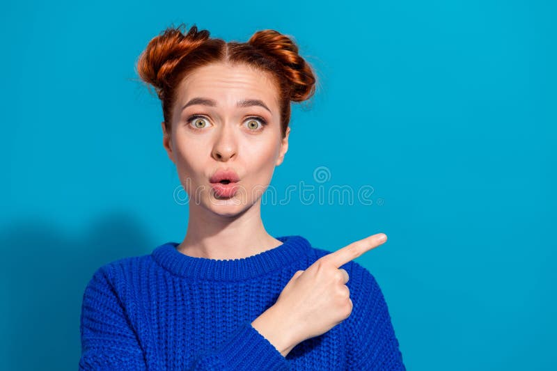 Young Woman with an Intrigued Expression Pointing To the Side Against a ...