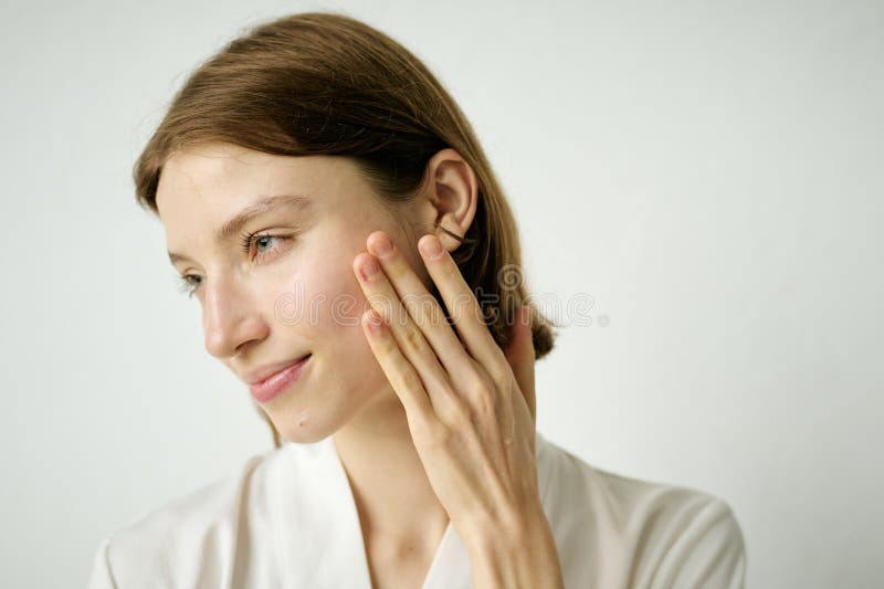 Young Lady Touching Cheek stock image. Image of care - 347529775