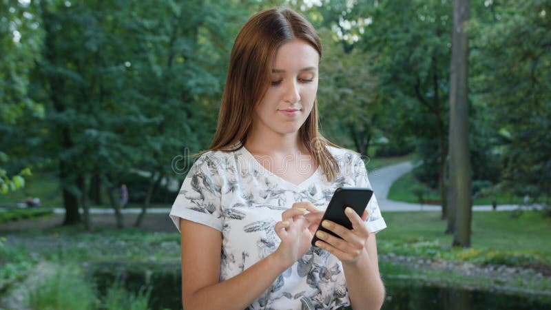 Young Lady Using a Phone in Town Stock Photo - Image of device, lady ...