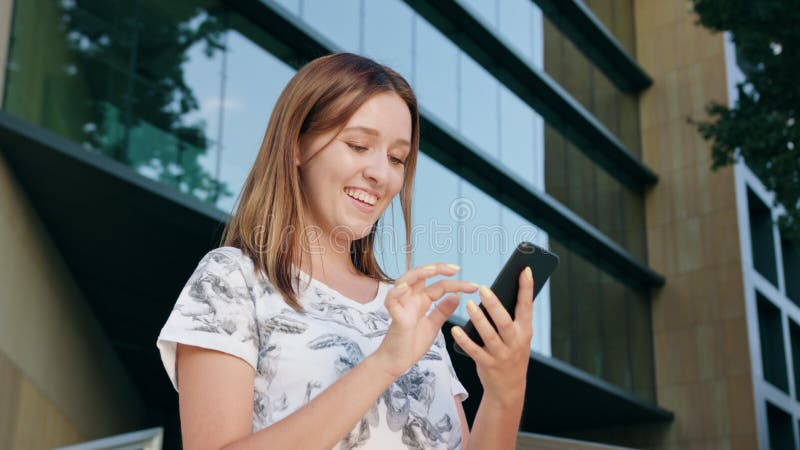 Young Lady Using a Phone in Town Stock Image - Image of holding, model ...
