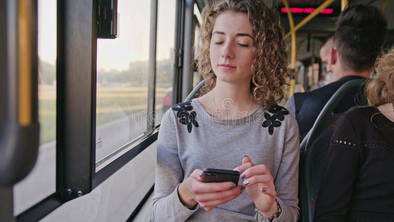 A Young Lady Using a Smartphone on the Bus Stock Photo - Image of ...