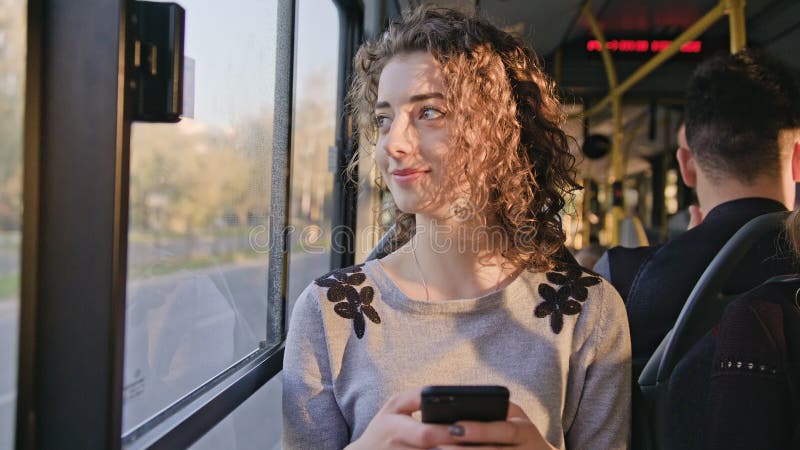 A Young Lady Using a Smartphone on the Bus Stock Image - Image of ...