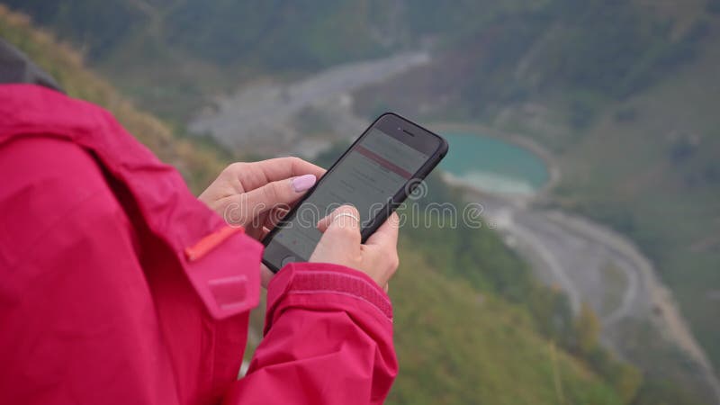 A Young Lady Using a Mobile Phone in Mountains. Stock Photo - Image of ...