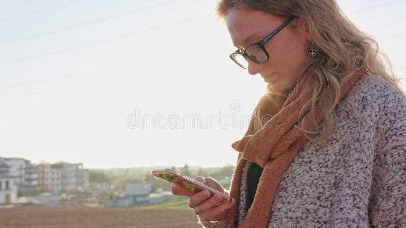 A Young Lady Using a Smartphone Outdoors Stock Image - Image of digital ...