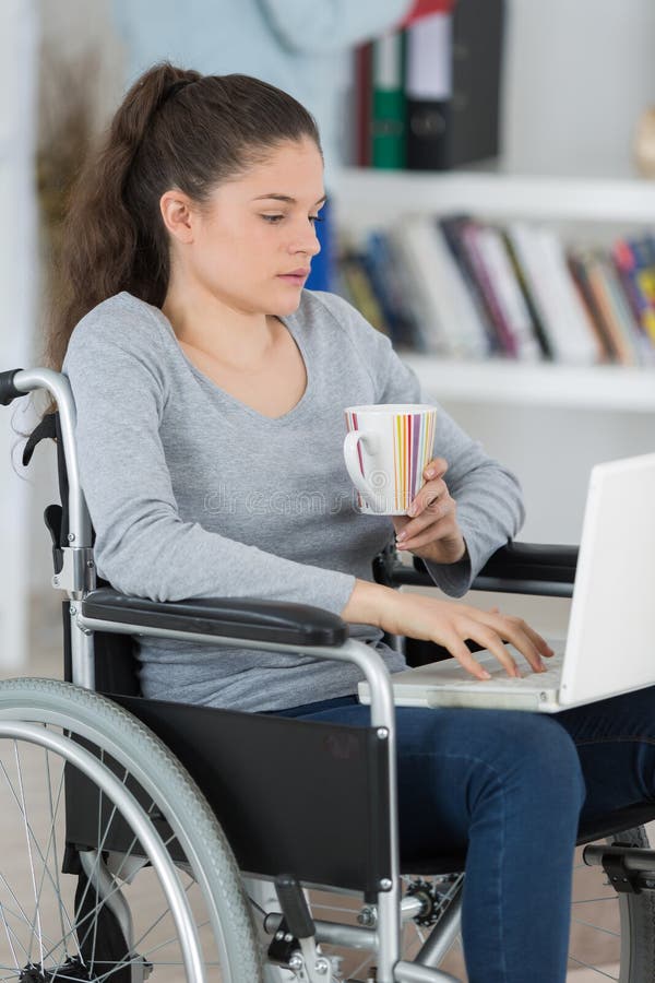 Young Lady in Wheelchair with Laptop and Cup Stock Image - Image of ...