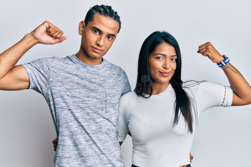 Young Latin Couple Wearing Casual Clothes Strong Person Showing Arm