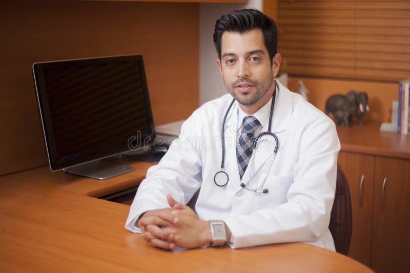 Young latin doctor at work stock image. Image of coat - 34488931