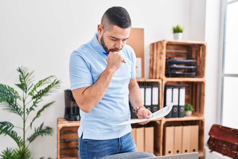 Young Latin Man Business Worker Reading Document at Office Stock Photo ...