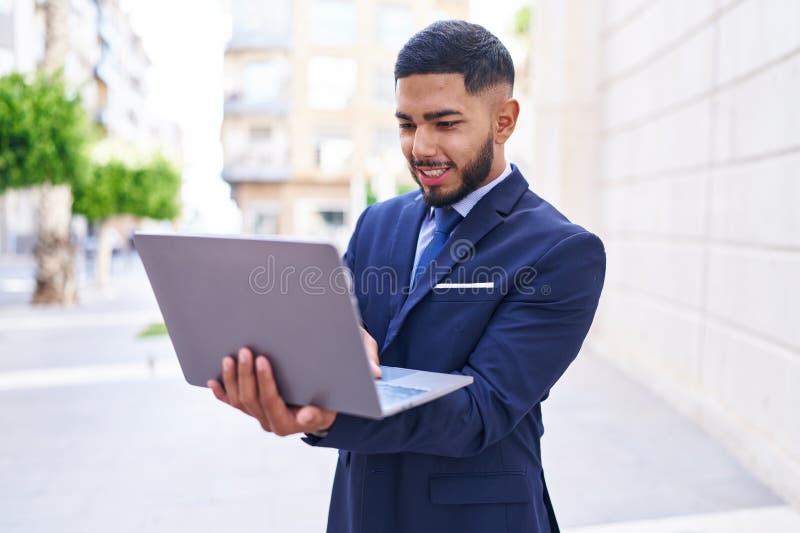 Young Latin Man Business Worker Smiling Confident Using Touchpad at ...