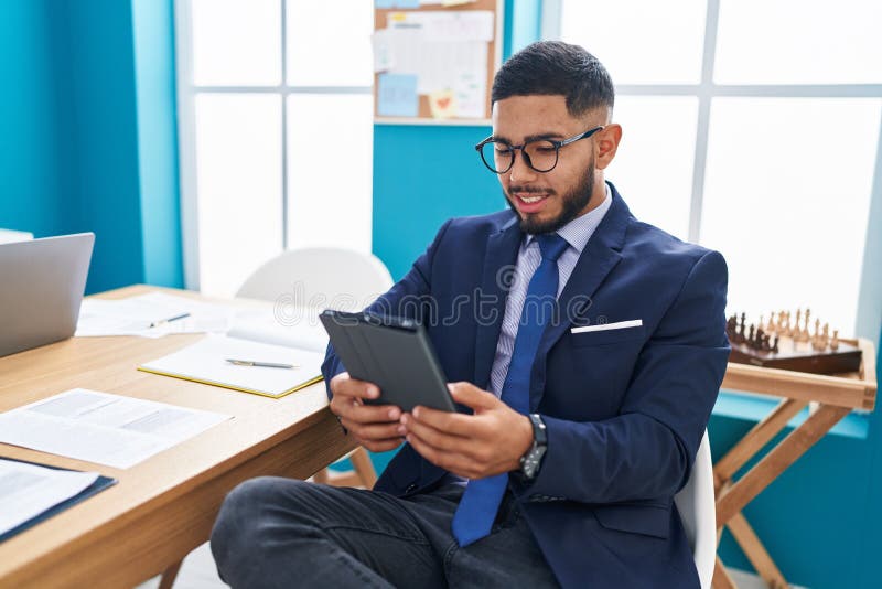 Young Latin Man Business Worker Using Touchpad Working at Office Stock ...