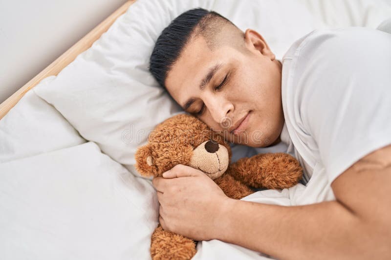 Young Latin Man Hugging Teddy Bear Lying on Bed Sleeping at Bedroom ...