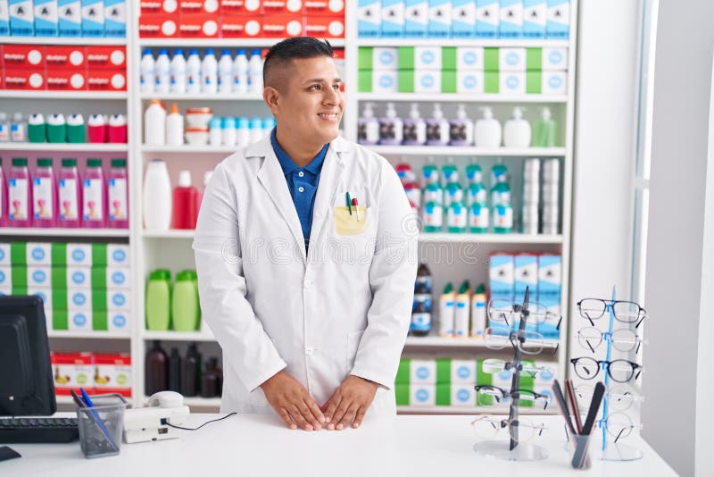 Young Latin Man Pharmacist Smiling Confident Standing at Pharmacy Stock ...
