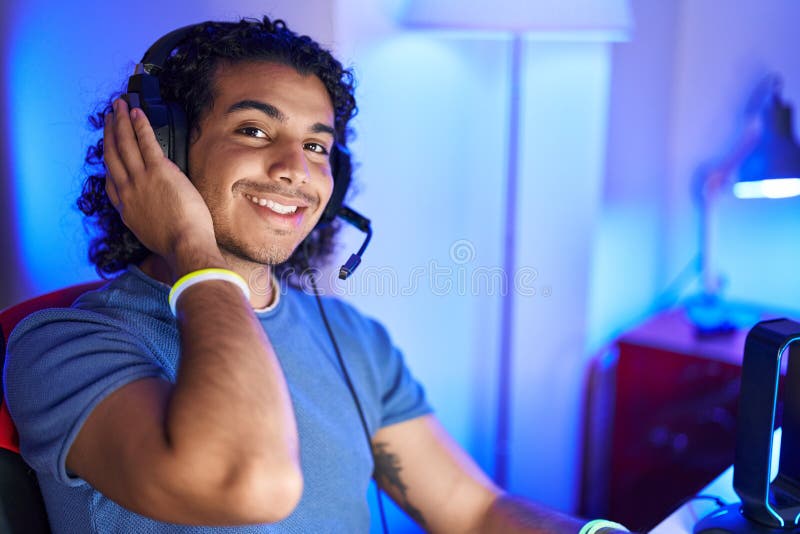 Young Latin Man Streamer Smiling Confident Sitting on Table at Gaming ...