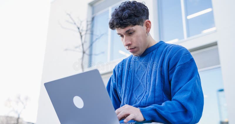 Focused Young Latin Student Working on Laptop Outside University ...