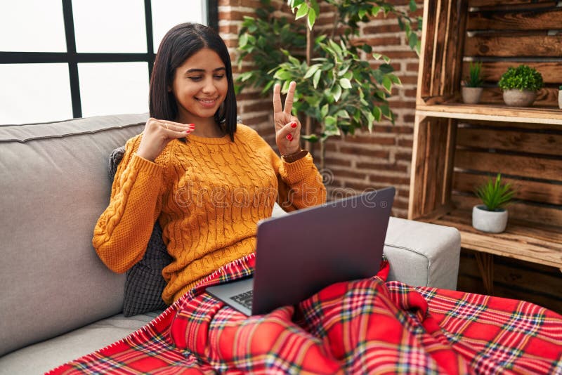 Young Latin Woman Having Video Call Using Deaf Sign Language at Home ...