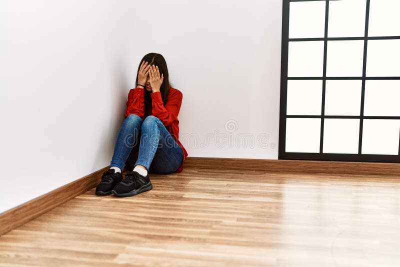 Young Latin Woman Sitting on the Floor Crying at Empty Room Stock Photo ...