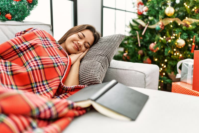 Young Latin Woman Sleeping Lying on Sofa by Christmas Tree at Home ...