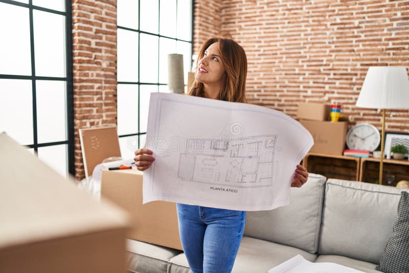 Young Latin Woman Smiling Confident Holding House Plan at Hew Home ...