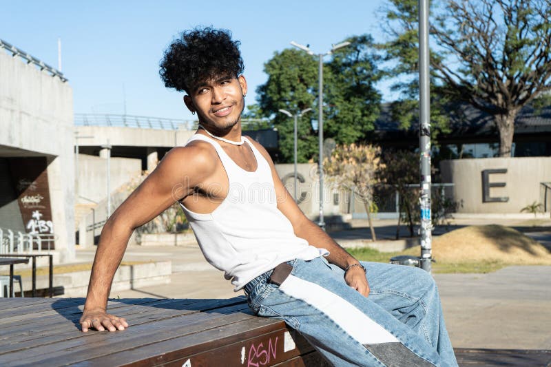 Young Latino Man Sitting on a Wooden Platform in a Square Stock Photo ...