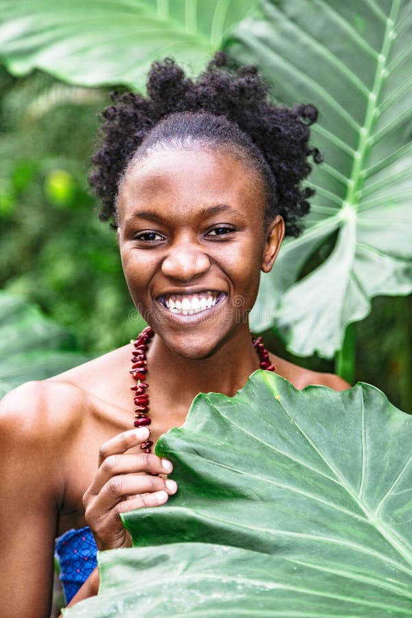 Young African Girl Covered with Large Leaf of Tree Stock Image - Image ...