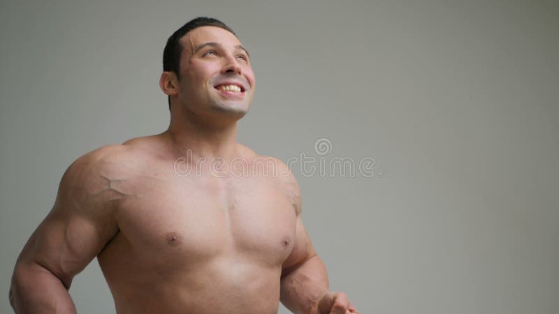 Young Laughing Muscular Bodybuilder Posing and Looking at Camera ...