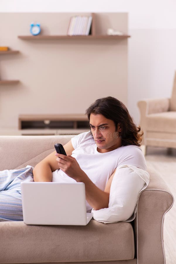 Young Lazy Man in Oversleeping Concept at Home Stock Photo - Image of ...