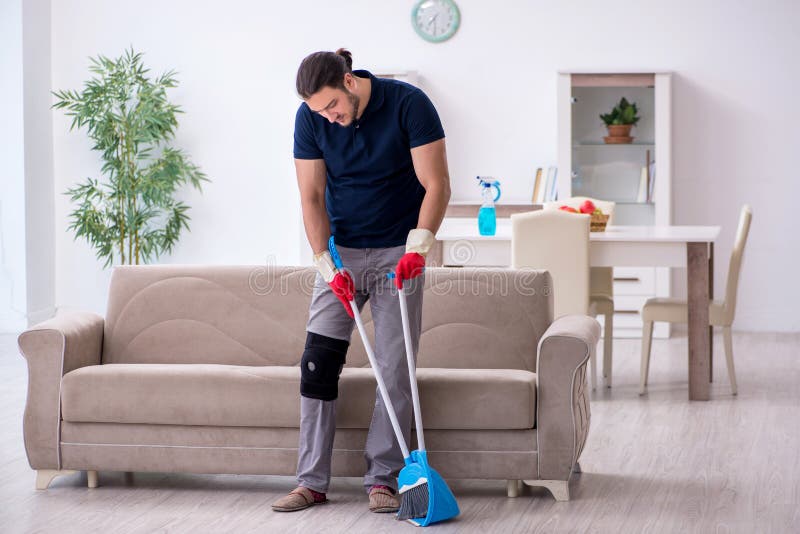 Young Leg Injured Contractor Cleaning the House Stock Photo - Image of ...