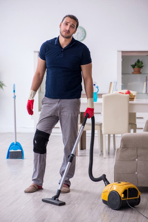 Young Leg Injured Contractor Cleaning the House Stock Photo - Image of ...