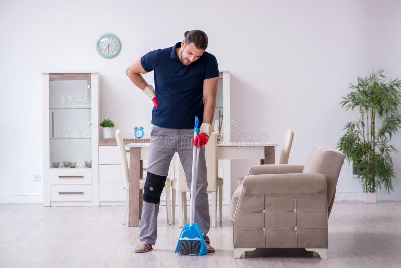 Young Leg Injured Contractor Cleaning the House Stock Image - Image of ...