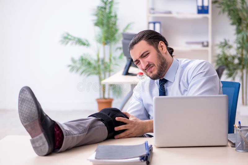 Young Leg Injured Employee Working in the Office Stock Photo - Image of ...