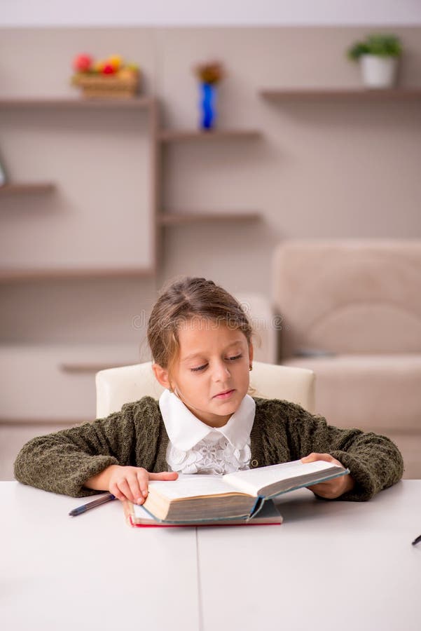 Young Little Girl Studying at Home Stock Photo - Image of book, study ...