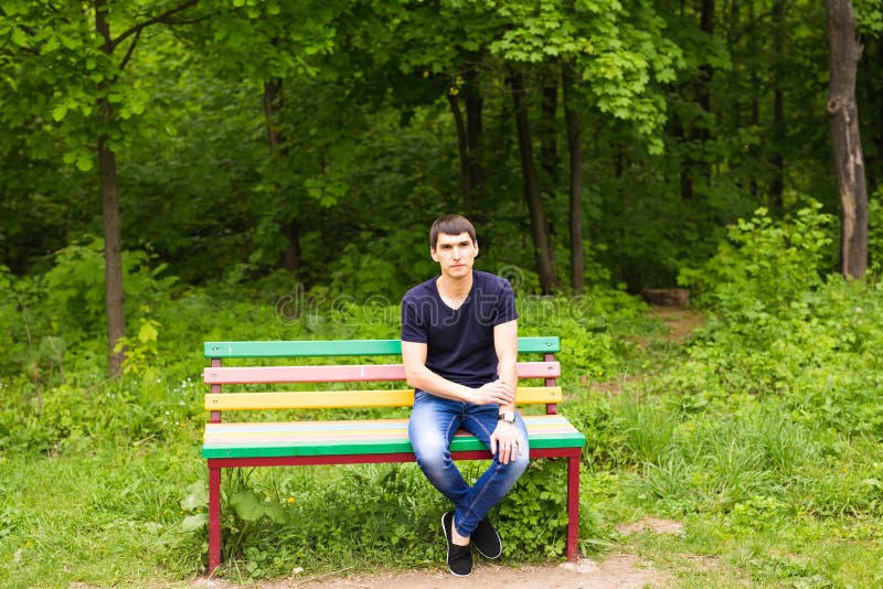 Young Lonely Man Sitting on a Bench Waiting for Something. Stock Photo ...