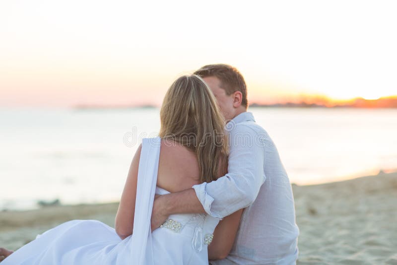 Young Love Couple Sitting Together on Beach Stock Photo - Image of ...