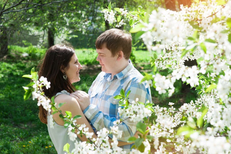 Young Loving Couple Walking in a Spring Garden Stock Image - Image of ...