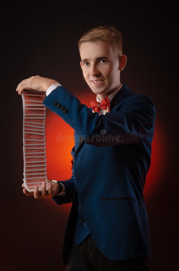 A Young Magician Guy is Holding Cards in His Hands Stock Photo - Image ...