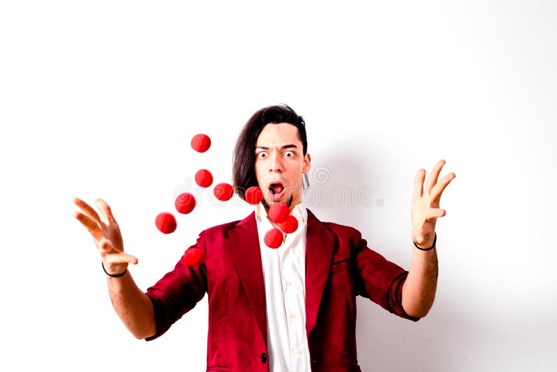 Young Magician Throwing Red Air Balls To Look for Luck Stock Photo ...