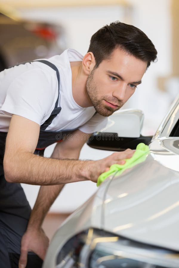 Young Maintenance Engineer Examining Car in Repair Shop Stock Photo ...