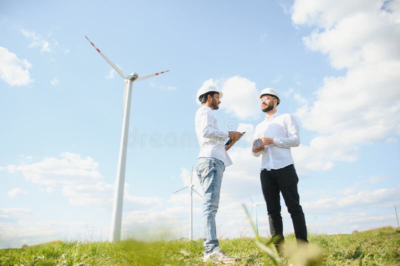 Young Maintenance Engineer Team Working in Wind Turbine Farm. Stock ...