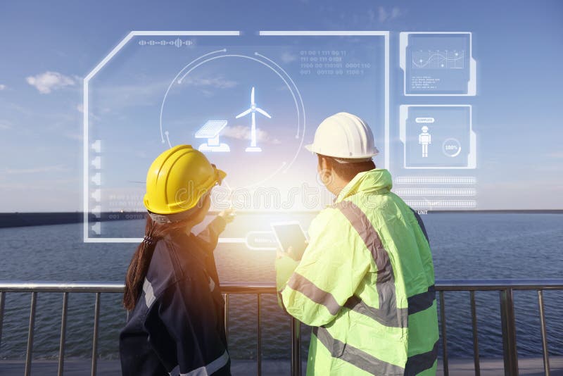 Young Maintenance Engineer Team Working in Wind Turbine Farm at Sunset ...