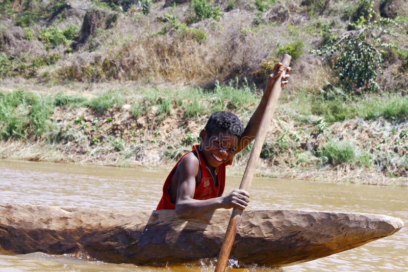 Young Malagasy African Boy Rowing Traditional Canoe Stock Photo - Image ...
