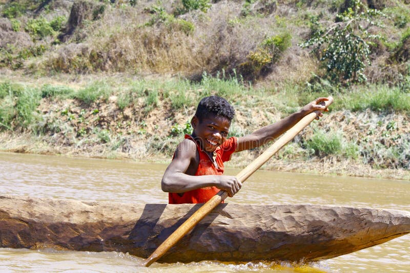 Young Malagasy African Boy Rowing Traditional Canoe Stock Photo - Image ...