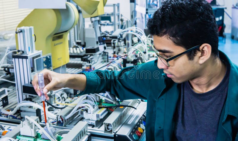 A Young Malay Engineering Student with Spectacles Working in the Lab ...