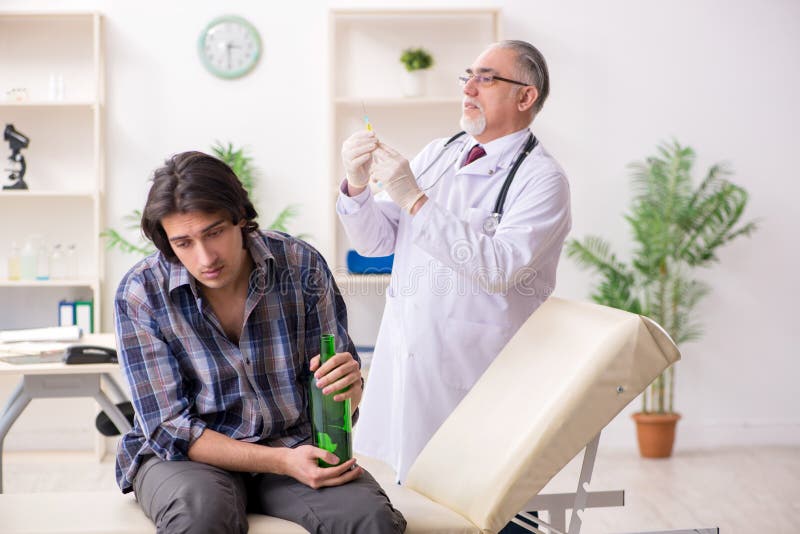 Young Male Alcoholic Visiting Old Doctor Stock Photo - Image of ...