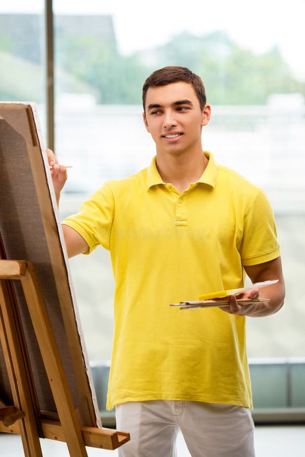 The Young Male Artist Drawing Pictures in Bright Studio Stock Photo ...