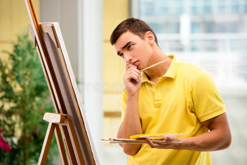 The Young Male Artist Drawing Pictures in Bright Studio Stock Photo ...