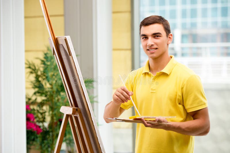 The Young Male Artist Drawing Pictures in Bright Studio Stock Image ...