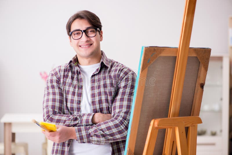 The Young Male Artist Drawing Pictures in Bright Studio Stock Photo ...