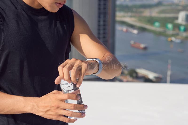 Young Male Athlete Checking Smartwatch, Over Shoulder View Stock Image ...