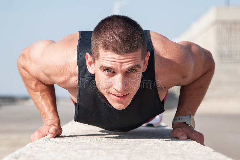 Young Male Athlete Doing Push-ups from the Floor in an Open Space Stock ...